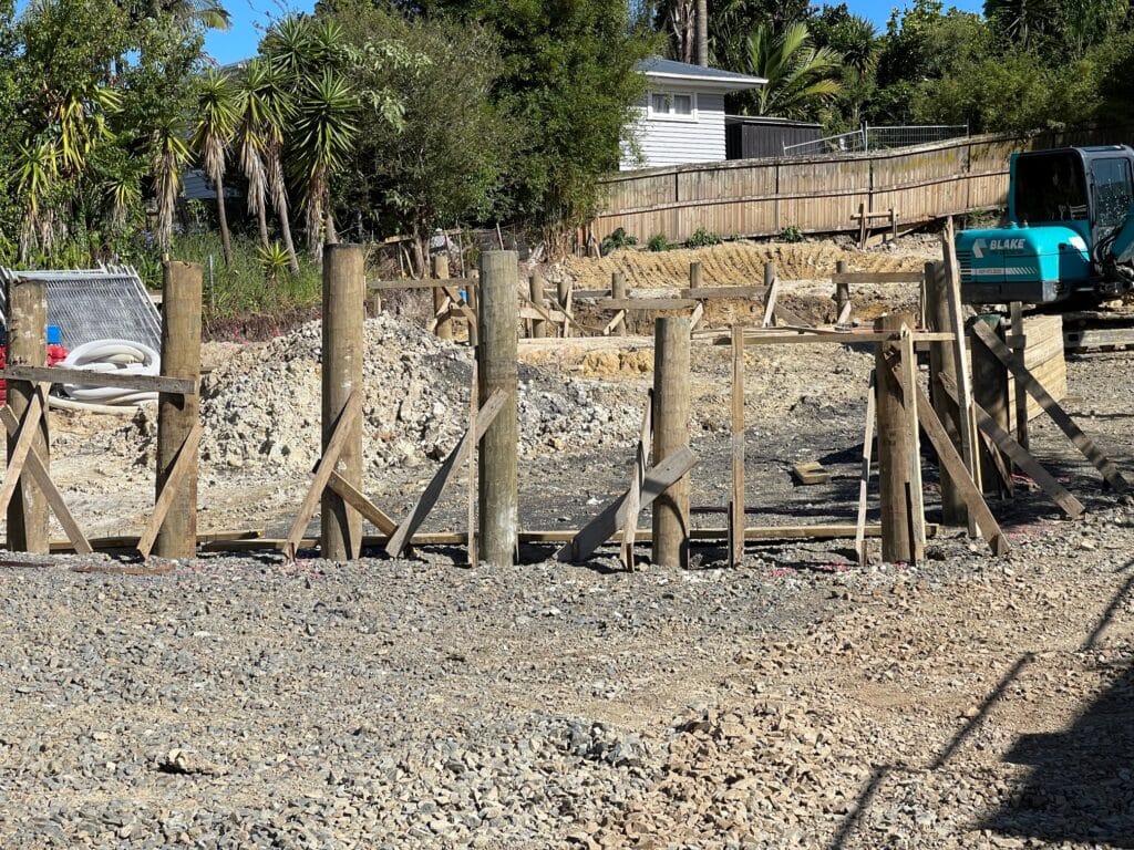 How does a 1 man team install large treated timber poles?